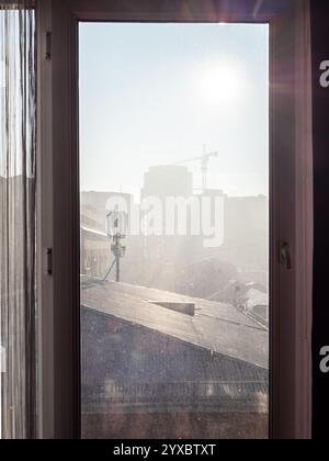 Sunrise in the city through a dusty window, winter scene Stock Photo ...