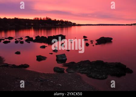 sunrise over calm water - Lysaker Stock Photo - Alamy