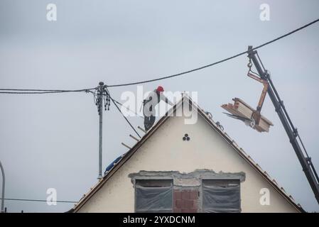 construction worker at topping out or roofing ceremony, when finishing ...