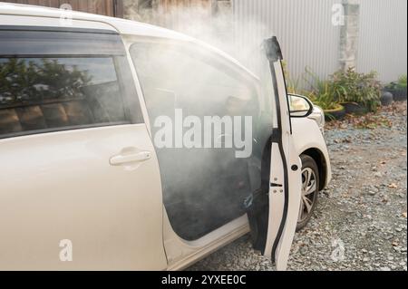 Smoke is coming from under the hood of the car Stock Photo - Alamy