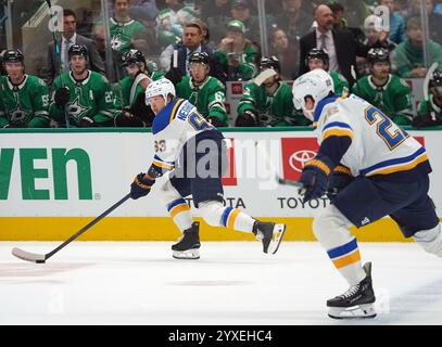 St. Louis Blues' Jake Neighbours, center, is checked by Calgary Flames ...