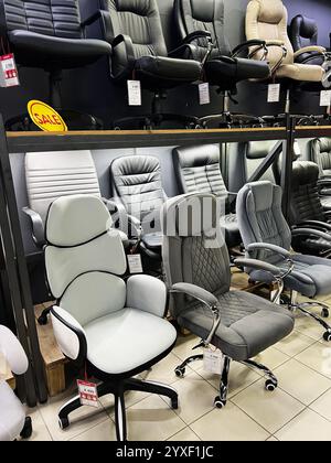 A selection of modern office chairs displayed inside a furniture store ...