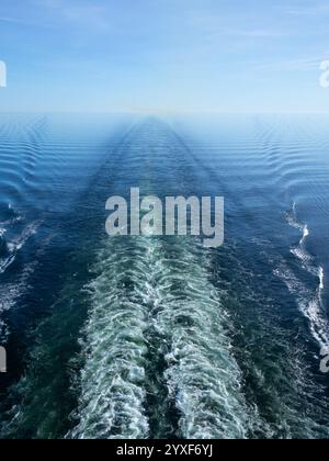 The turbulent wash from a large cruise ship flowing off to the horizon ...