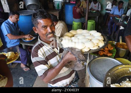 Vendor with a tray of freshly-made idli at a food stall in Chennai ...