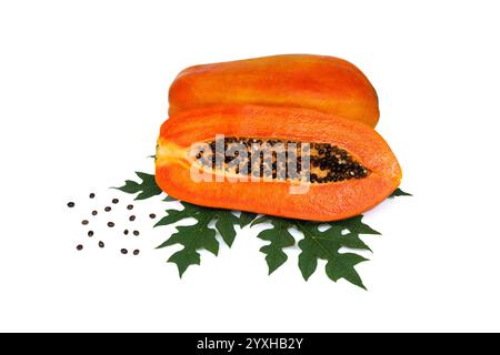 Vibrant whole green papaya and halved fruit revealing orange flesh and ...