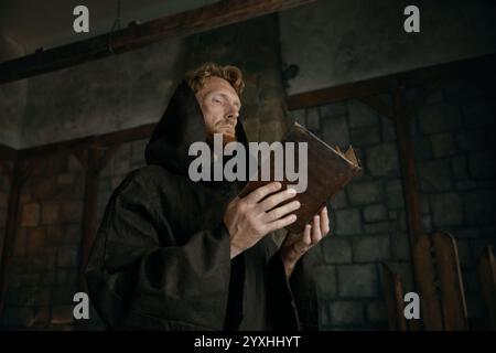 Thoughtful medieval monk reading ancient book in cathedral Stock Photo ...