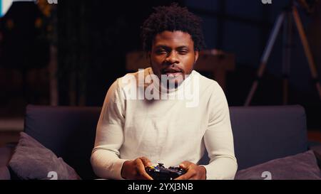 Cheerful gamer feeling excited after finally defeating all enemies and ...