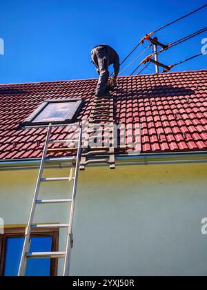 construction worker at topping out or roofing ceremony, when finishing ...