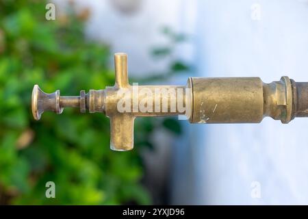Outdoor push-button tap made of yellow brass Stock Photo - Alamy