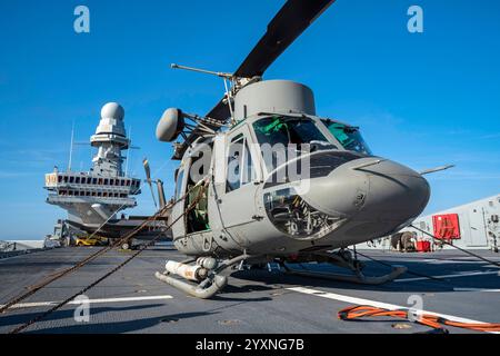 Italian Navy AB-212 ASW helicopter flying above the ITS Cavour aircraft ...