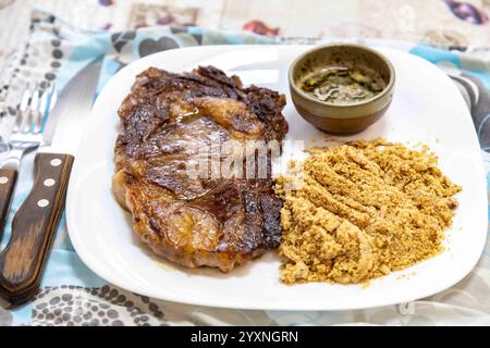 Typical Brazilian lunch with grilled steak, farofa and sauce Stock ...