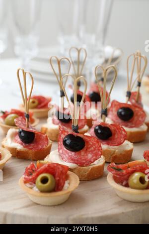 Tasty canapes on wooden board Stock Photo - Alamy