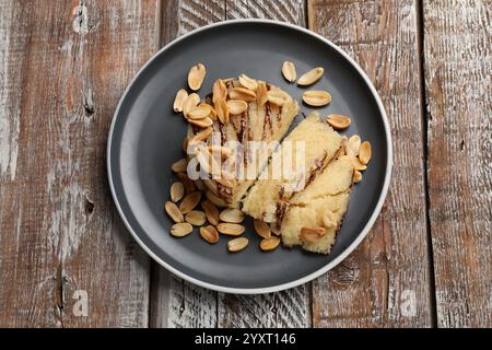 Delicious sweet semolina halva with peanuts on plate, closeup Stock ...
