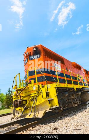 Colorful, powerful looking train engine parked in the railroad switch ...