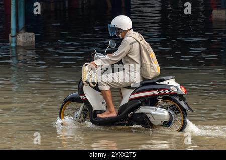 A motorcycle rides through a street in the Balat neighborhood of the ...
