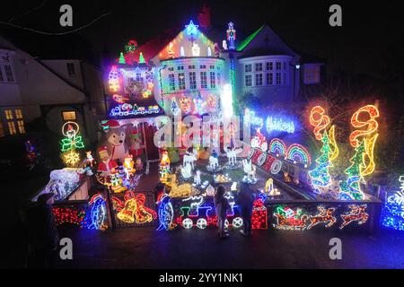 People admiring the Christmas light display at a house in Highgate ...
