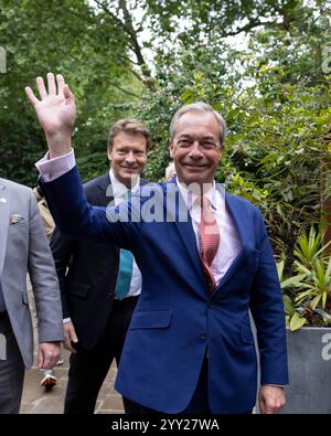 Reform UK leader Nigel Farage waits off stage prior to his speech at a ...