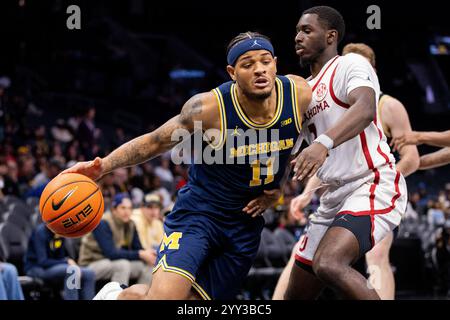 Oklahoma guard Brycen Goodine (2) drives against Missouri guard Jacob ...