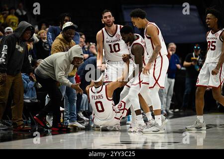 Oklahoma guard Jeremiah Fears (0) is fouled by Auburn guard Miles Kelly ...