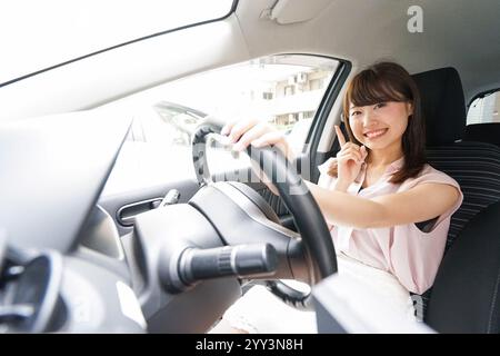Female driver pointing finger Stock Photo - Alamy