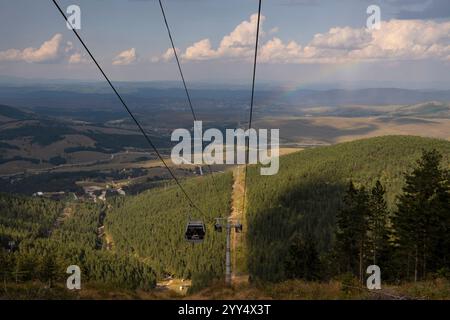 Cable car machinery mechanism mounted high above mountain, farmlands ...