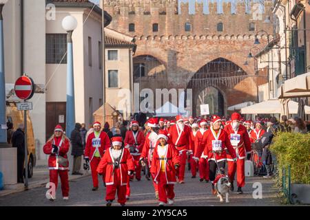 Runners pass by the ‘Rocca dei Tempesta’ during the traditional Santa ...