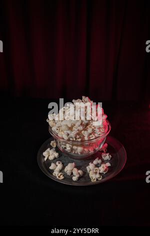 A bowl of popcorn placed on dark background in center. Top view Stock ...
