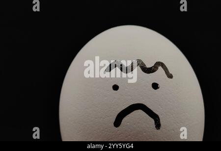 A sad egg on White background Stock Photo - Alamy