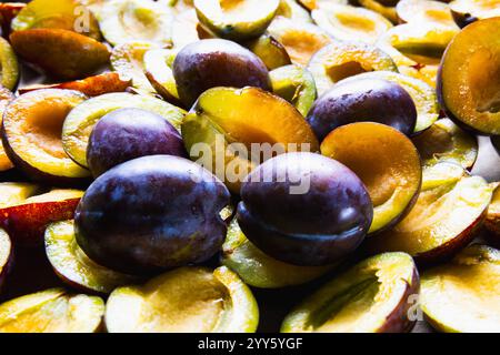 A close-up of Hungarian plums cut in half, ready for drying Stock Photo ...