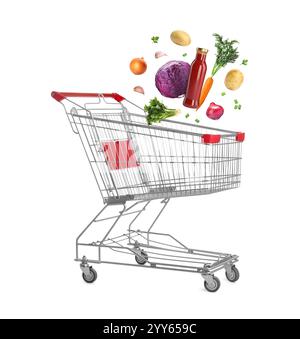 Groceries falling into shopping cart on white background Stock Photo ...