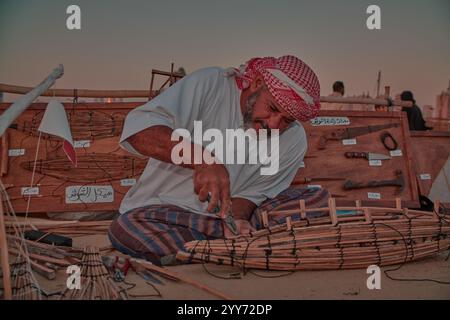 Traditional Arabic carpenter (dhow maker) working in Katara cultural ...