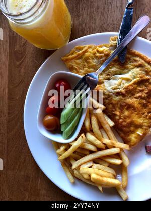 Homemade eggs with French fries and fried bacon on plate - close up ...