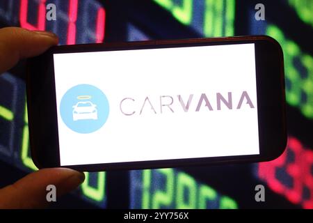 In this photo illustration, the Carvana company logo is seen displayed ...