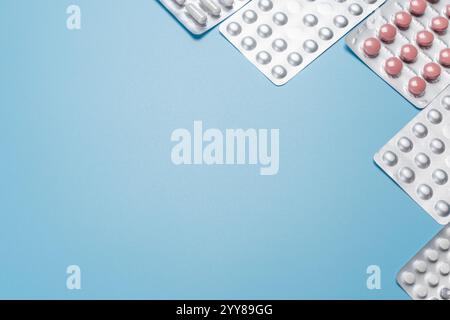 top view of blister packs with different pills on crimson textured ...