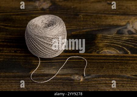 linen sewing threads in production, a new skein of grey thread is used ...