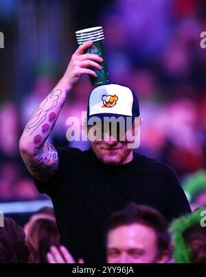 Singer songwriter Ed Sheeran drinks from a cup while being encouraged ...