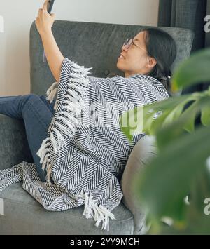 young asian woman having video call consultation waving greeting using ...