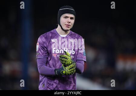 Derby County goalkeeper Jacob Widell Zetterstrom (left) makes a save ...