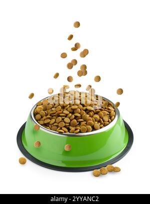 Dry pet food falling into bowl on white background Stock Photo - Alamy
