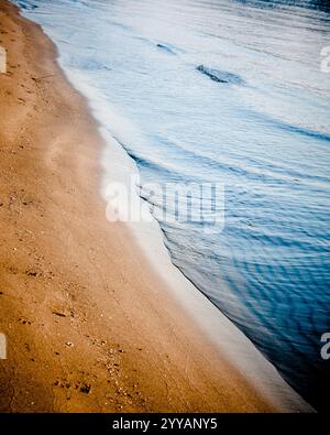 Blue sea gently touching beach, tropical coast scene, bright sky ...