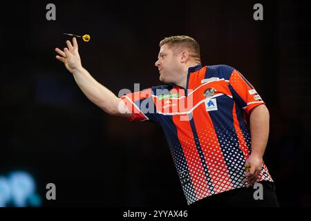 James Hurrell in action against Michael van Gerwen (not pictured ...