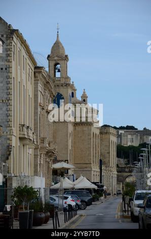 The view of the clock tower of Malta Maritime Museum over the water of ...