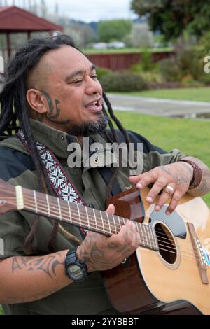 Maori man singing and playing guitar in New Zealand Stock Photo - Alamy