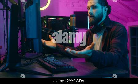 Caucasian gamer man addict puzzled influencer streaming play videogame ...