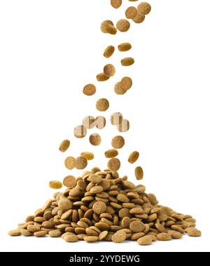 Dry pet food falling onto heap on white background Stock Photo - Alamy