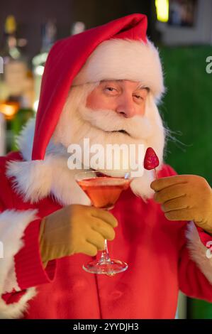 Santa Claus drinking a cocktail at a bar Stock Photo - Alamy