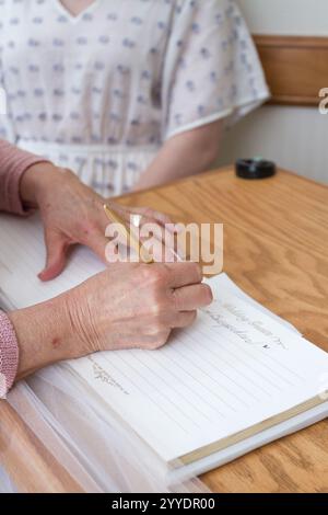 Female hands writing wedding to do list on table Stock Photo - Alamy