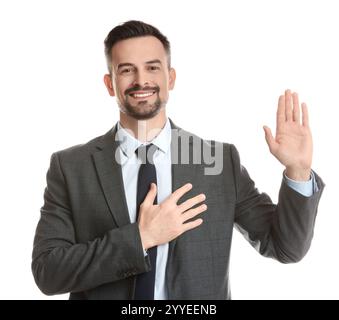 Man making promise with raised hand on white background. Oath gesture ...