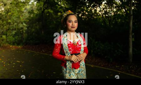 Traditional Javanese dancers wear red costumes that are full of details ...