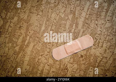 First aid adhedsive plaster isolated with text space on brown ...